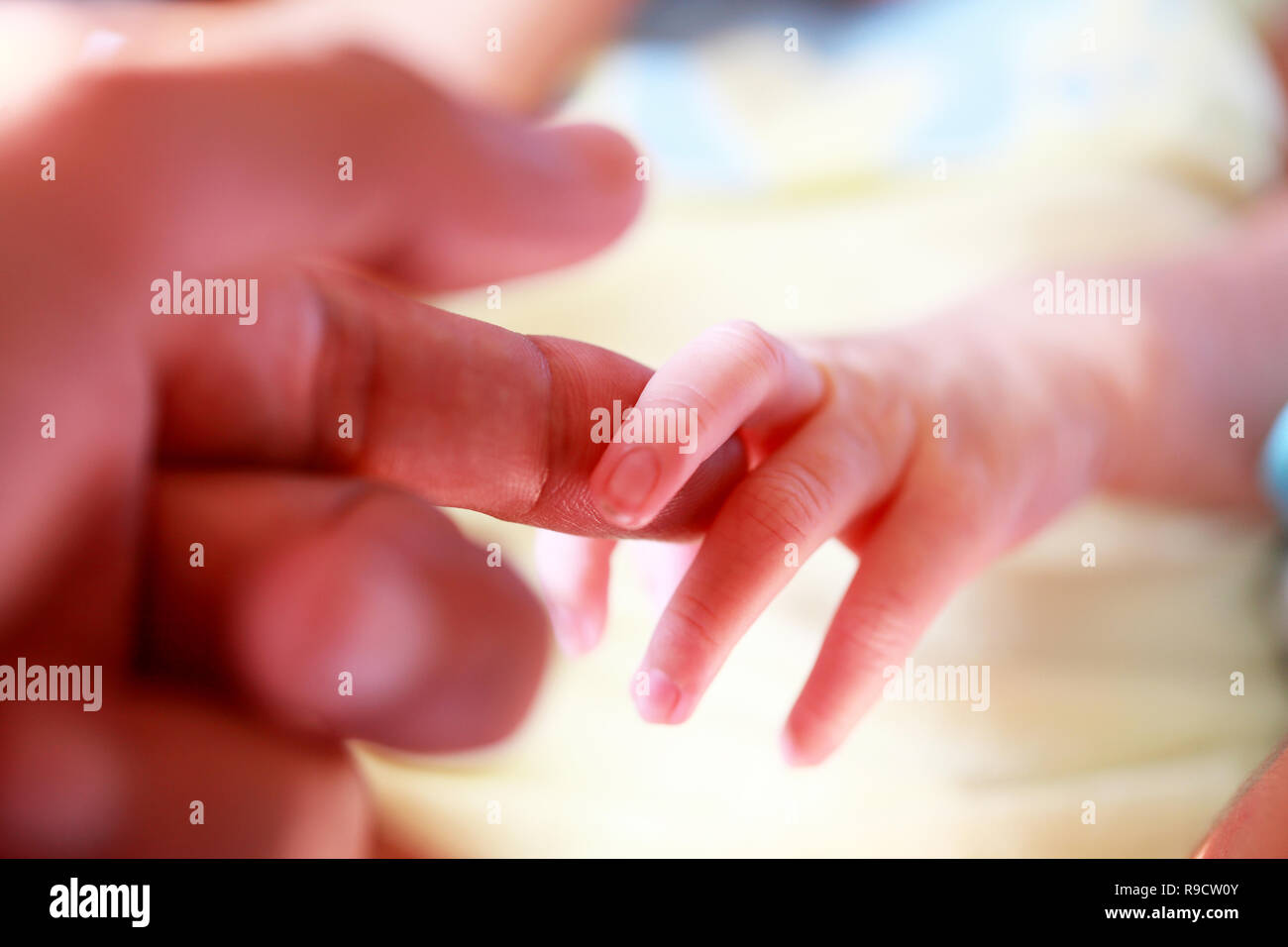 Sleeping baby holding finger mothers hi-res stock photography and ...