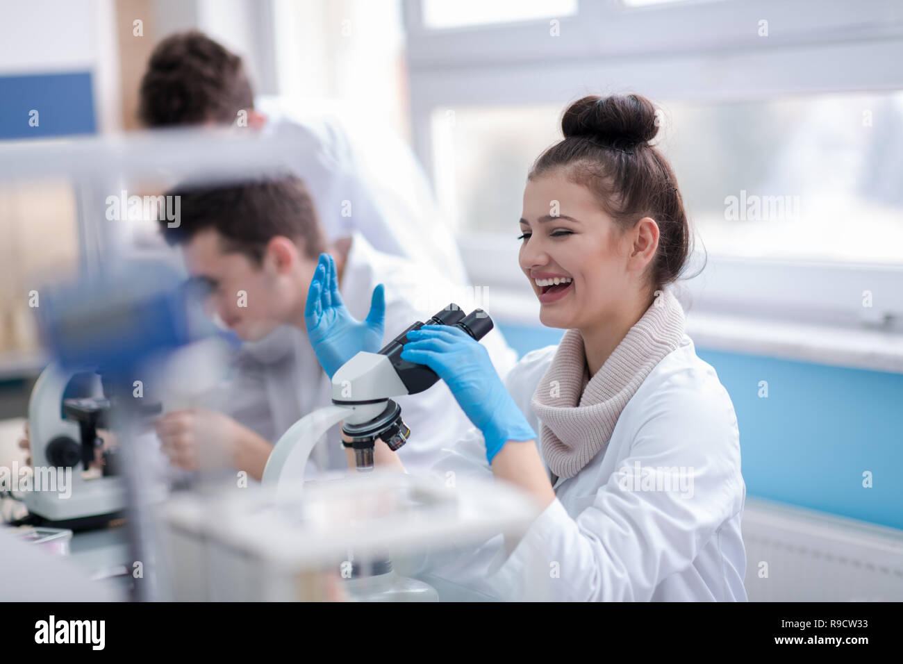 Group of young medical students doing research together in chemistry ...