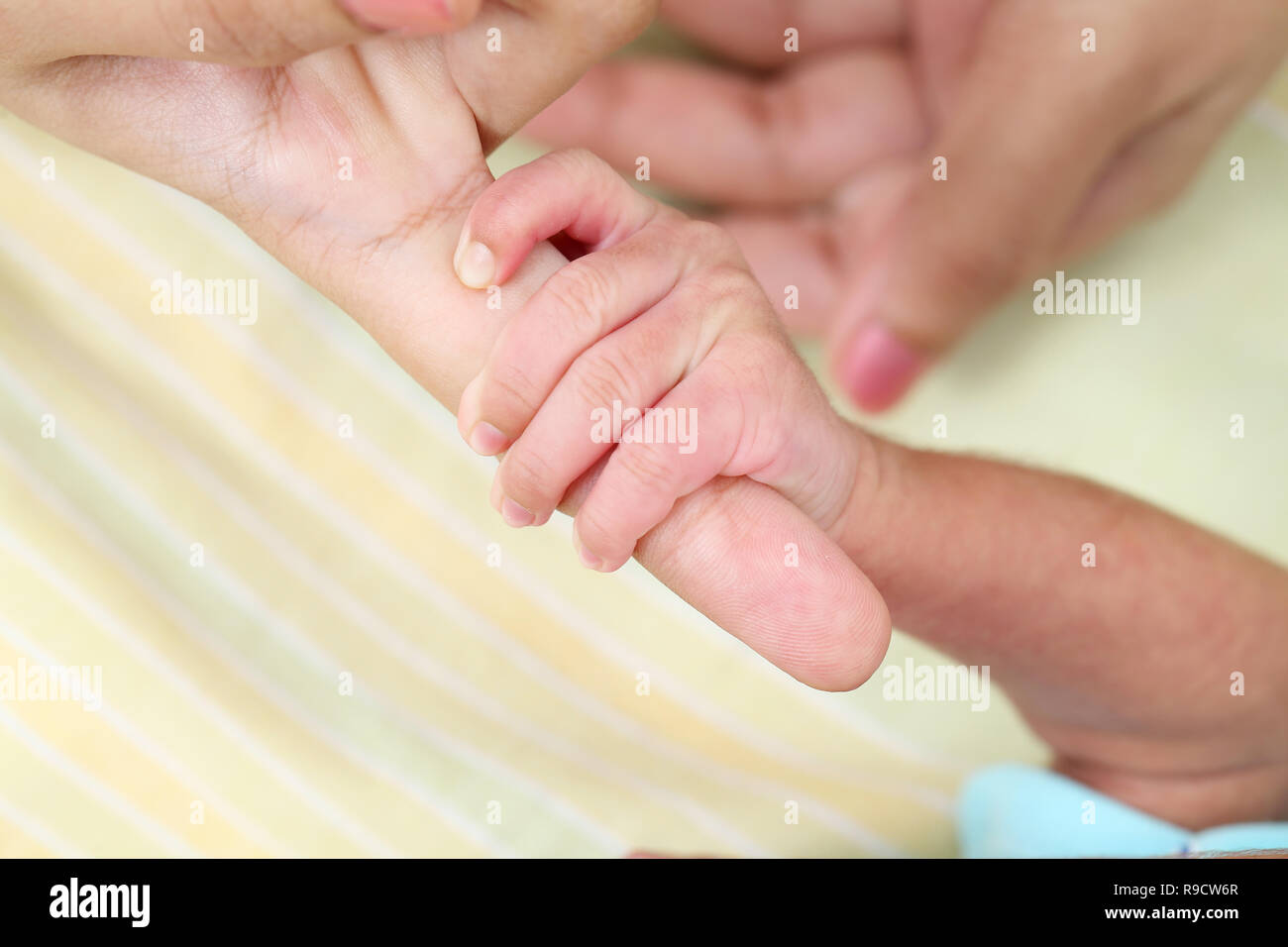 Sleeping baby holding finger mothers hi-res stock photography and ...