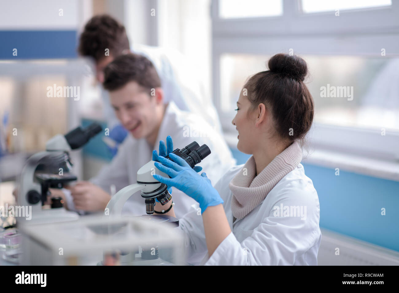 Group of young medical students doing research together in chemistry ...