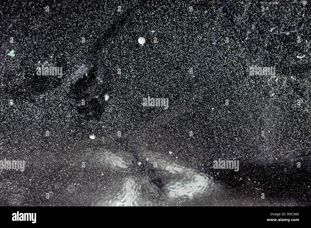 White powder dust on black tile floor Stock Photo - Alamy