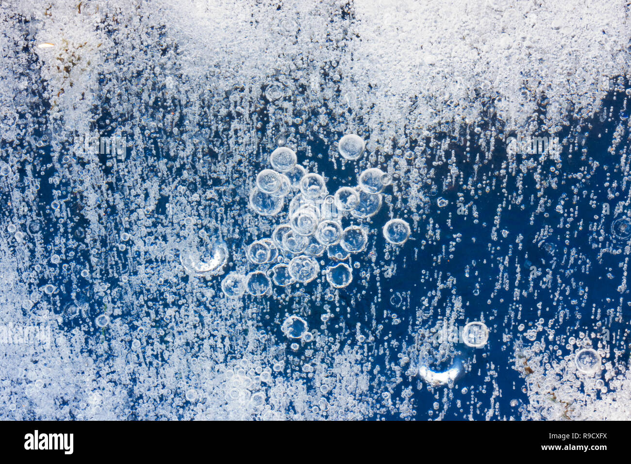 Big and small gas bubbles captured in blue ice Stock Photo - Alamy