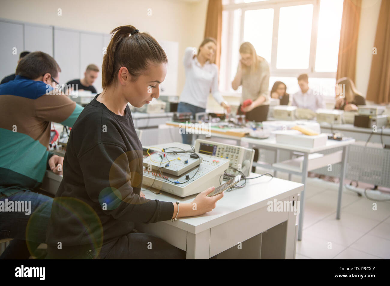Group of young students doing technical vocational practice with ...