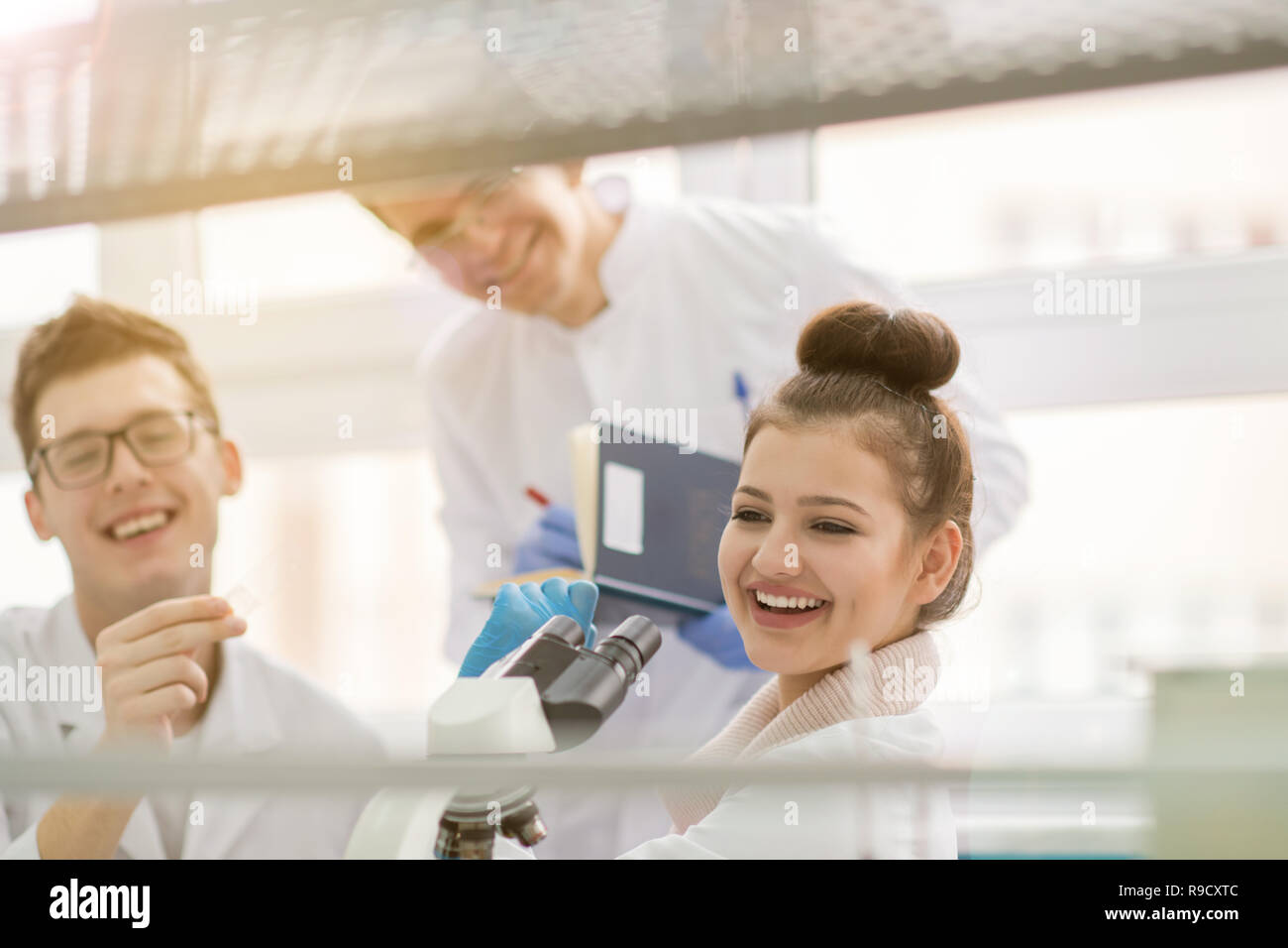 Group of young medical students doing research together in chemistry ...