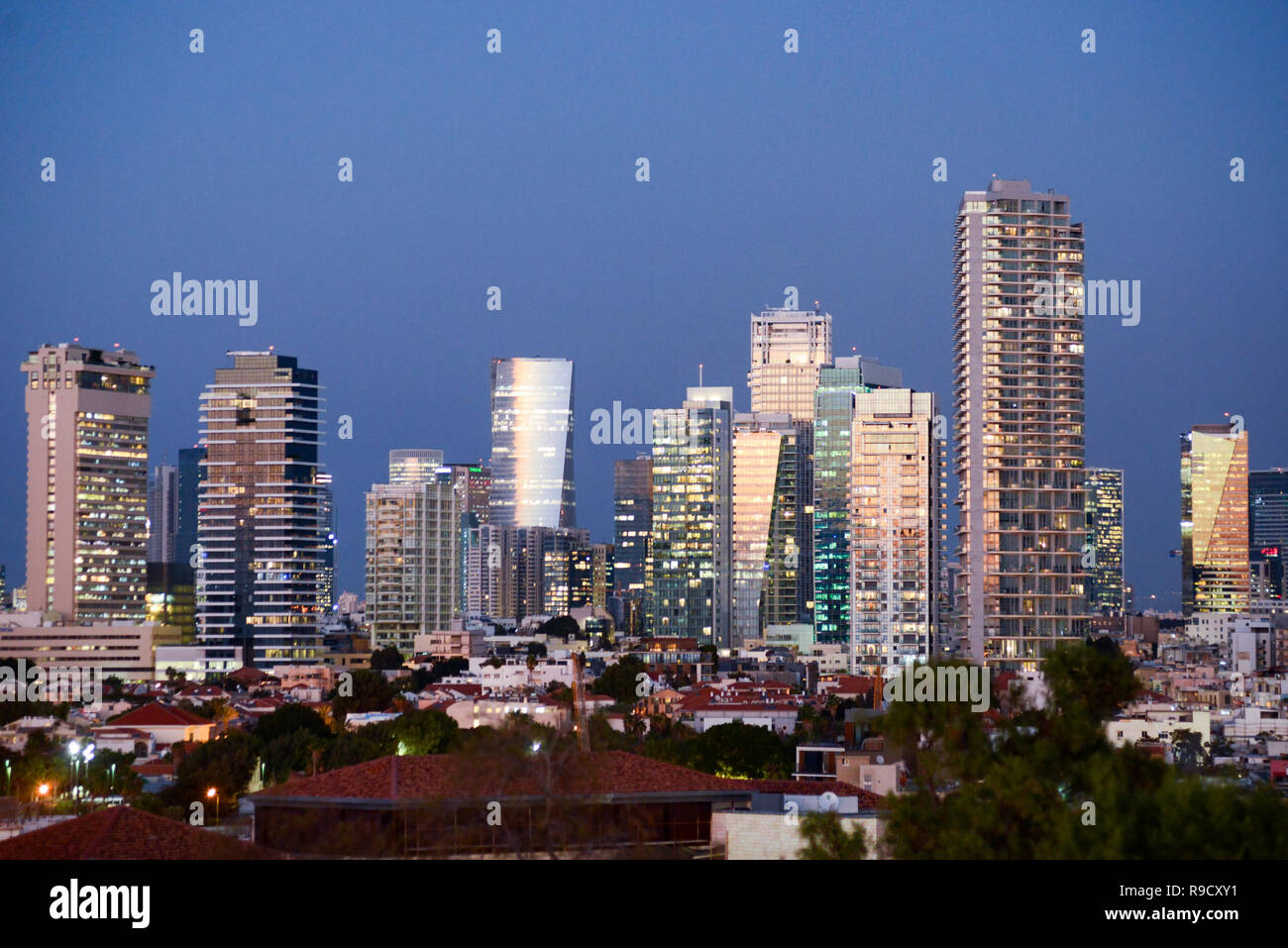 Downtown buildings reflect the setting sunlight in the bustling sea ...