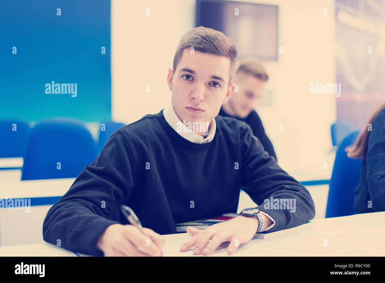 young male student writing notes in the classroom Stock Photo - Alamy