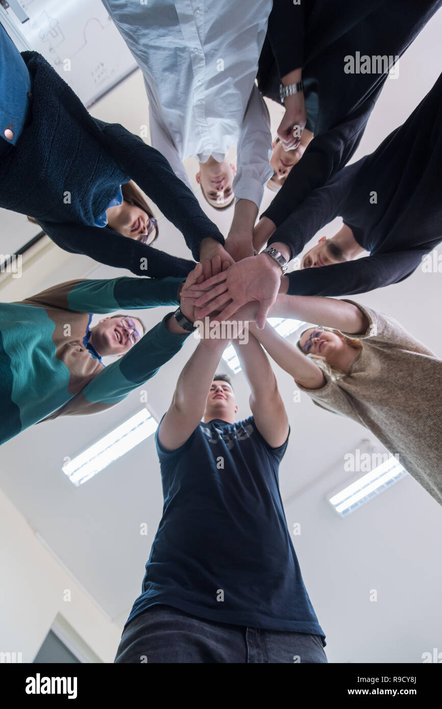 Group of young students in electronics classroom celebrating ...