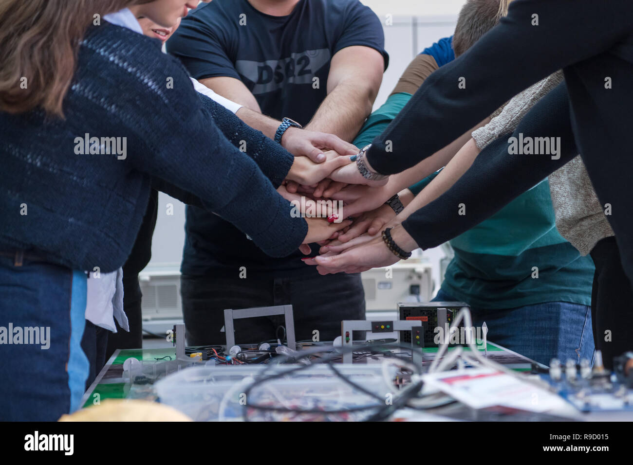 Group of young students in electronics classroom celebrating ...