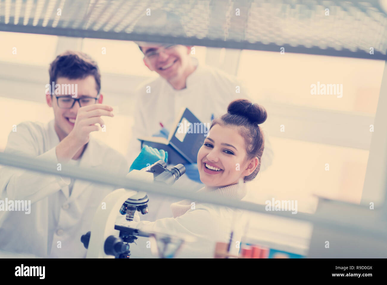 Group of young medical students doing research together in chemistry ...