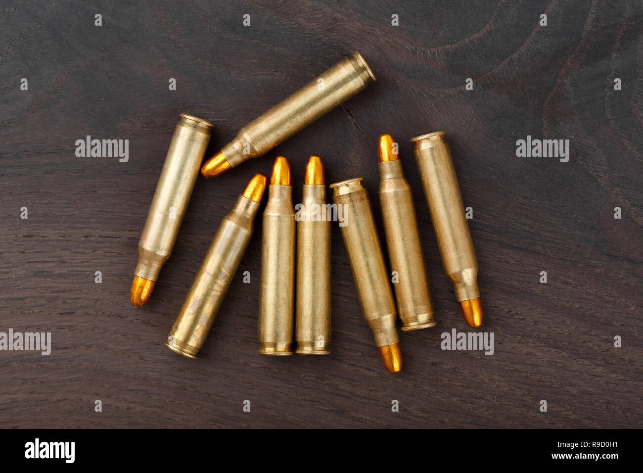 Bullets on wood background. A group of bullets for a gun on wood ...
