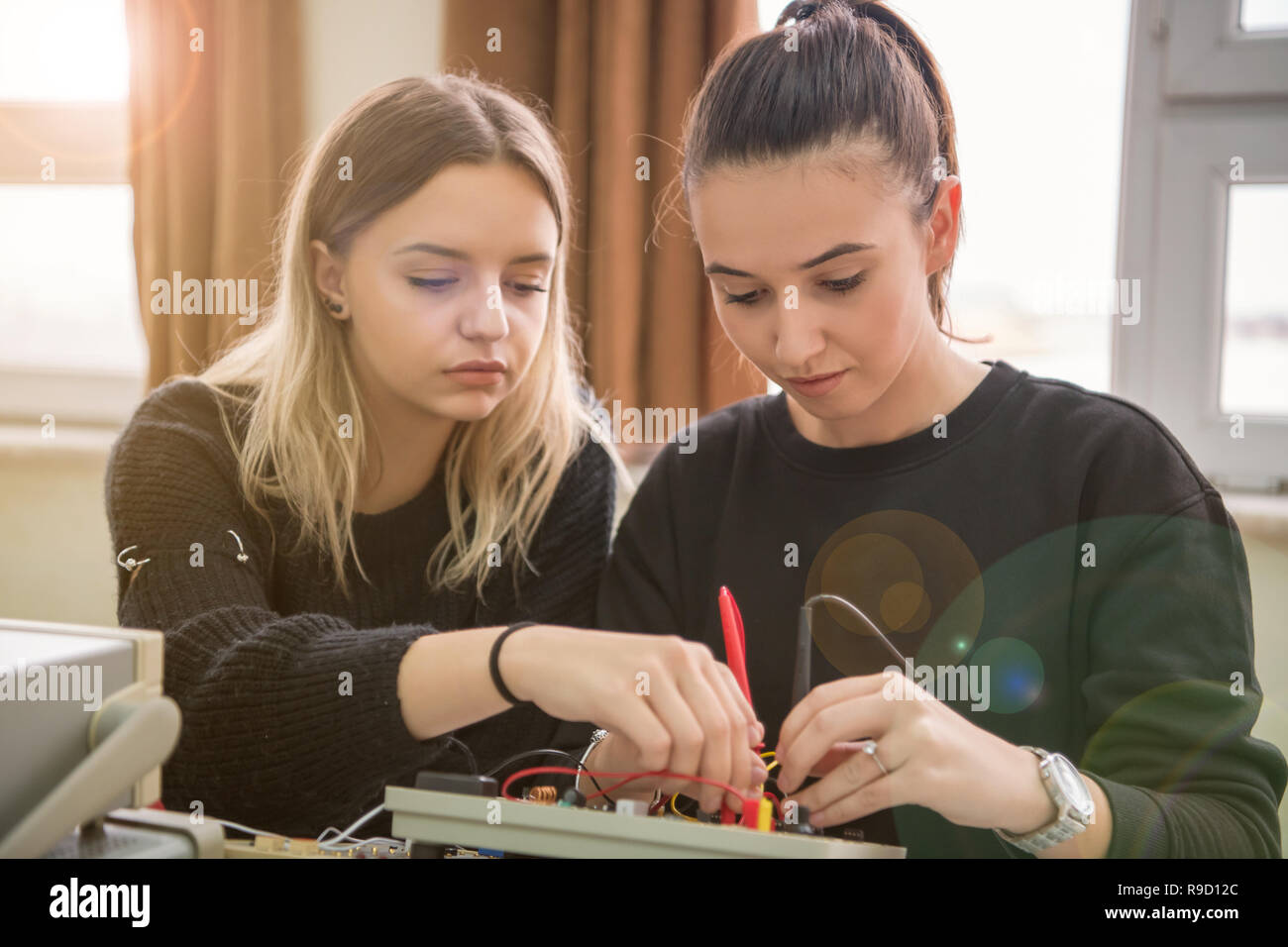 Group of young students doing technical vocational practice with ...
