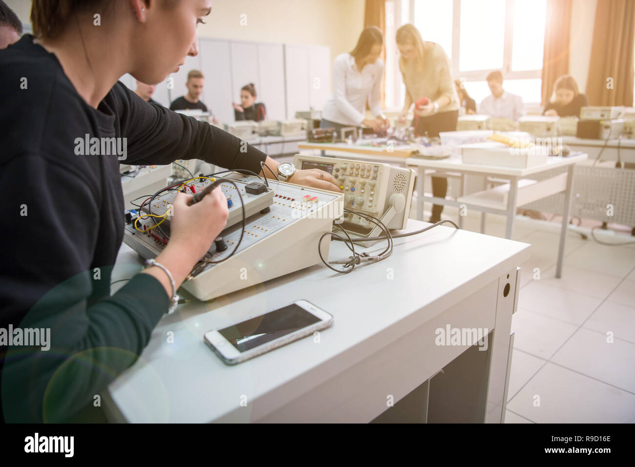 Group of young students doing technical vocational practice with ...