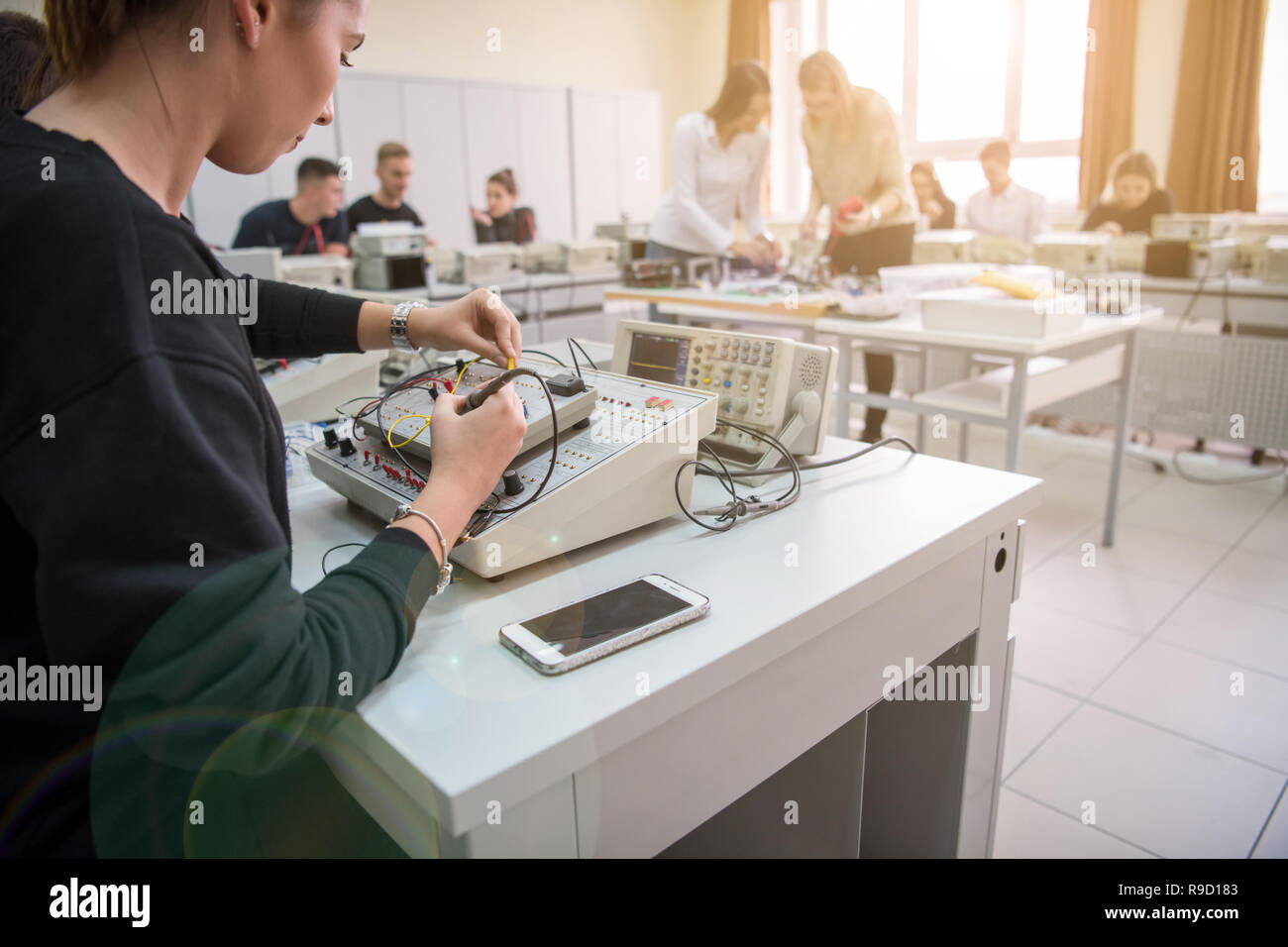 Group of young students doing technical vocational practice with ...