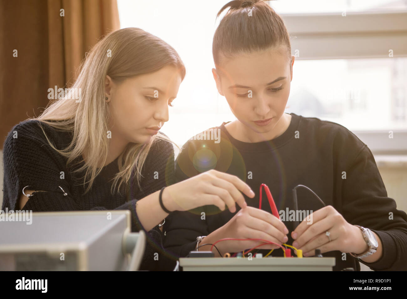 Group of young students doing technical vocational practice with ...