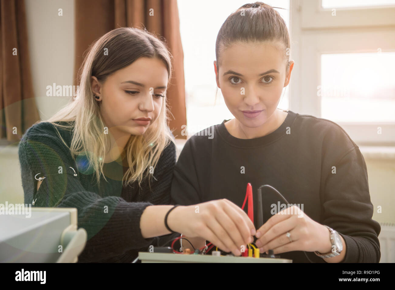 Group of young students doing technical vocational practice with ...