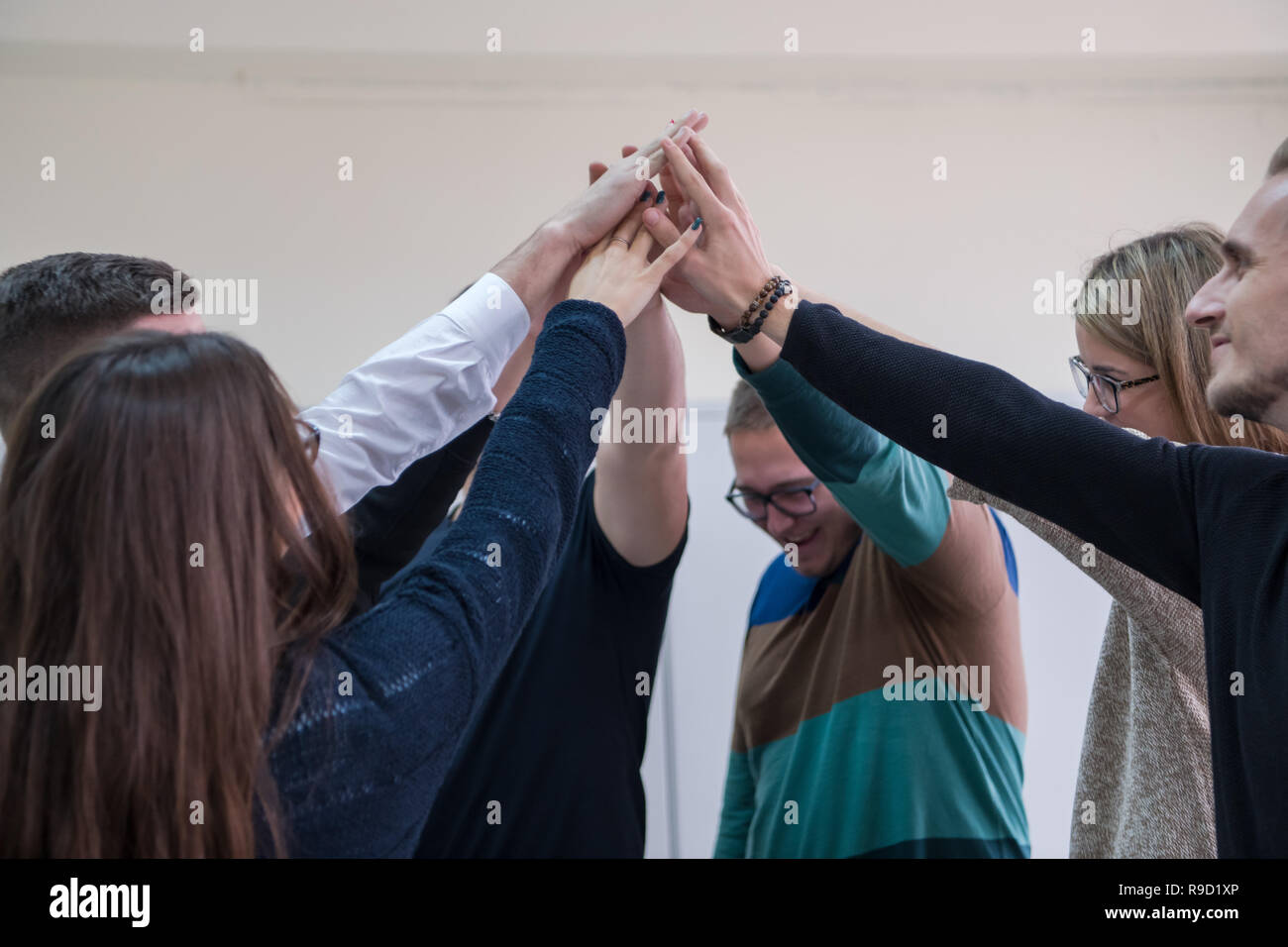 Group of young students in electronics classroom celebrating ...