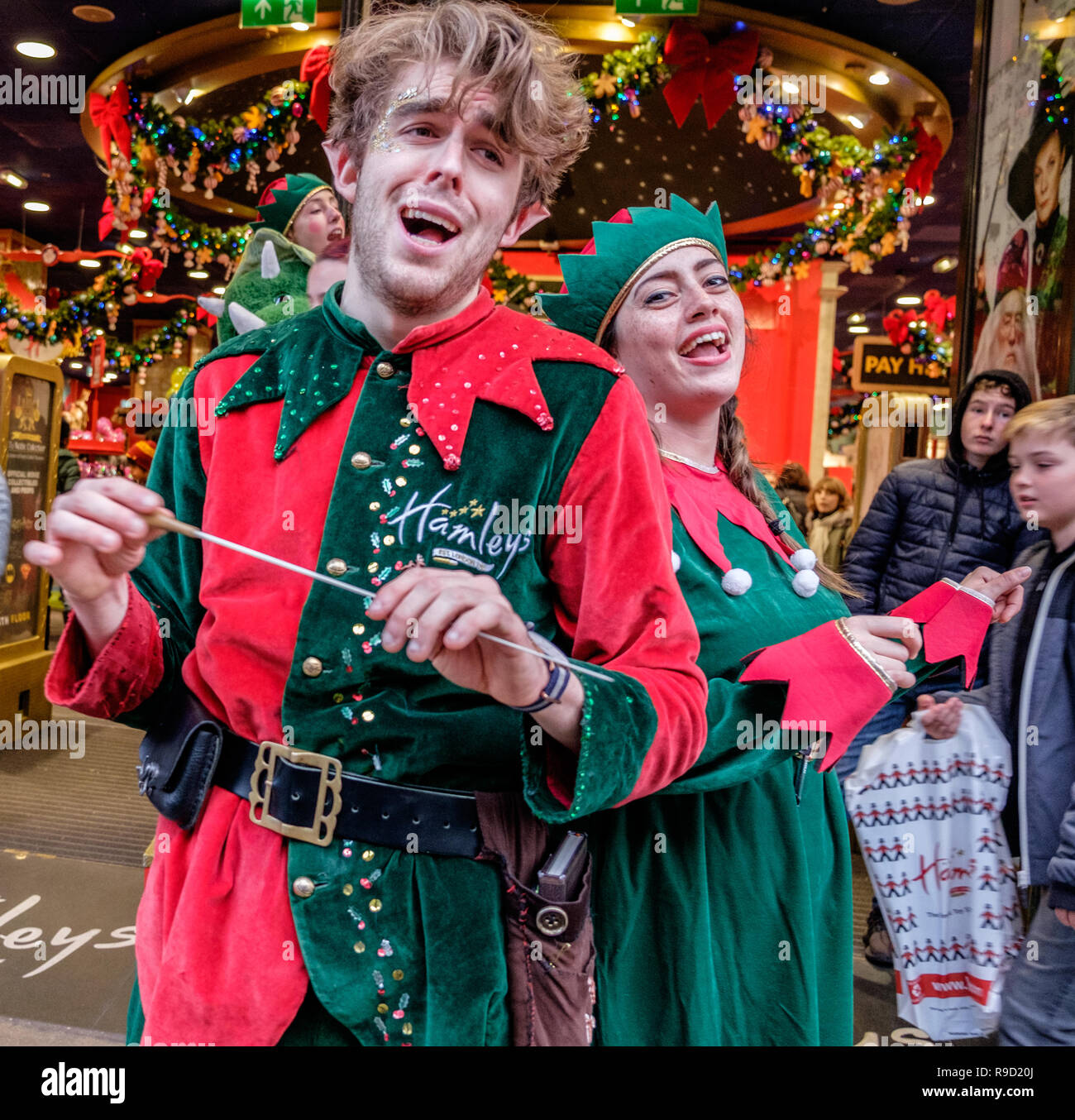 Elf Mike Rogers sings with a female elf in front of Hamleys Toy Store ...