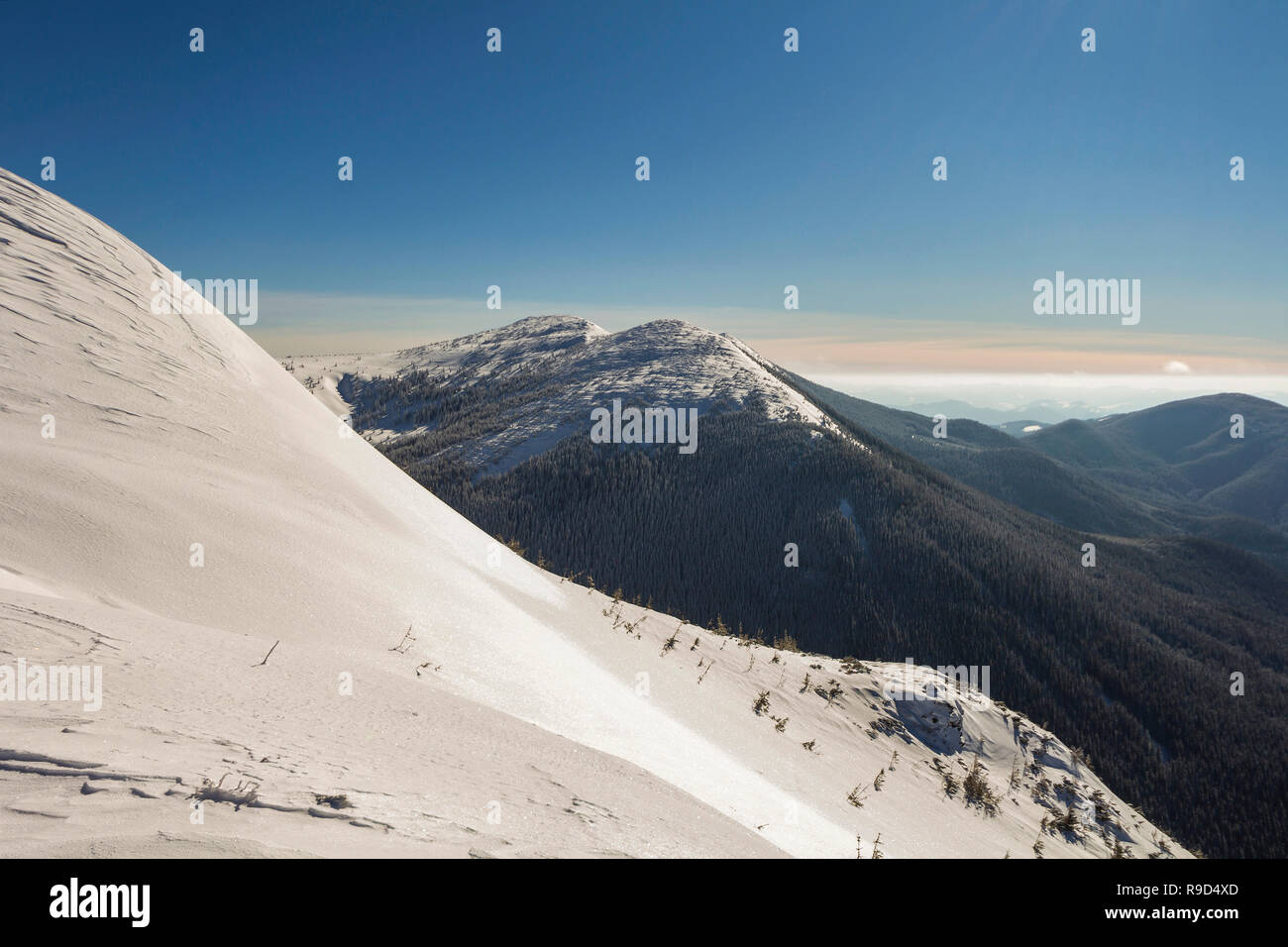 Beautiful winter landscape. Steep mountain hill slope with white deep ...