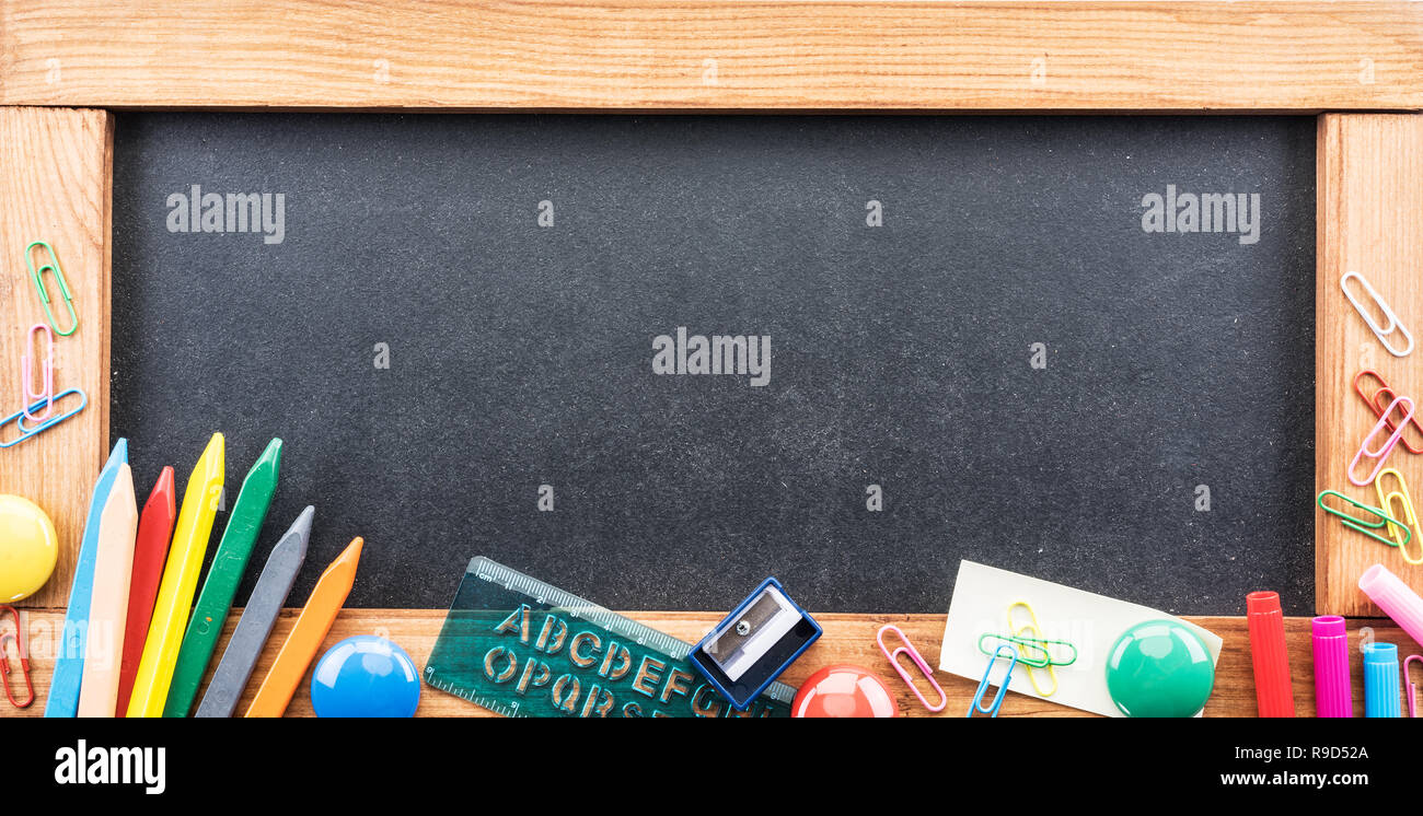 Blackboard and different school things. Close up Stock Photo - Alamy