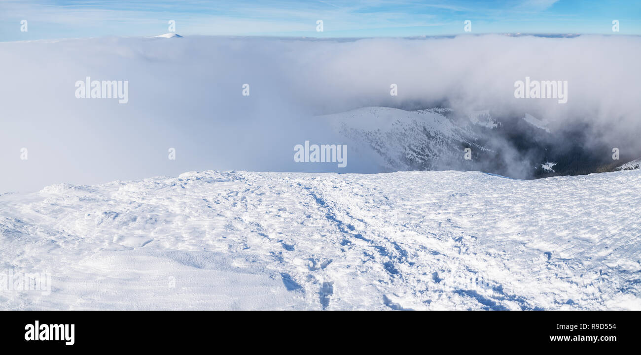 Mountain tops covered with snow above the white heavy clouds Stock ...