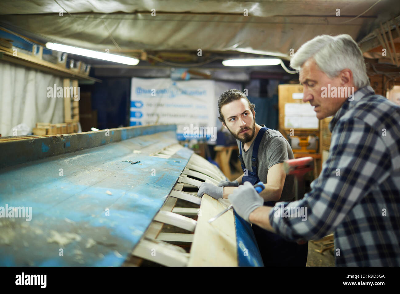 Teamwork in workshop Stock Photo - Alamy