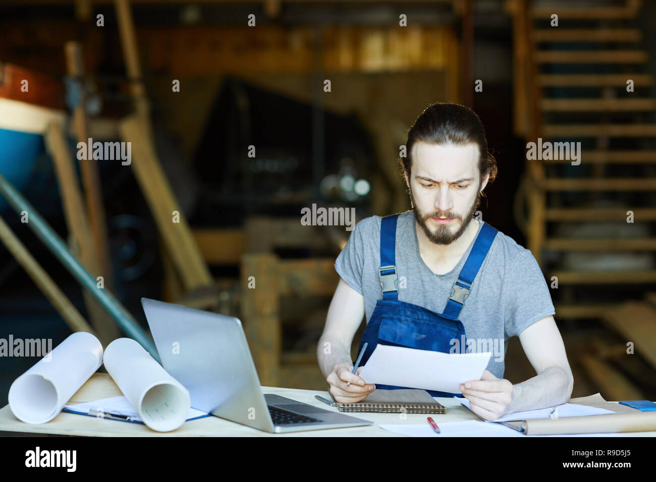 Engineer reading paper Stock Photo - Alamy