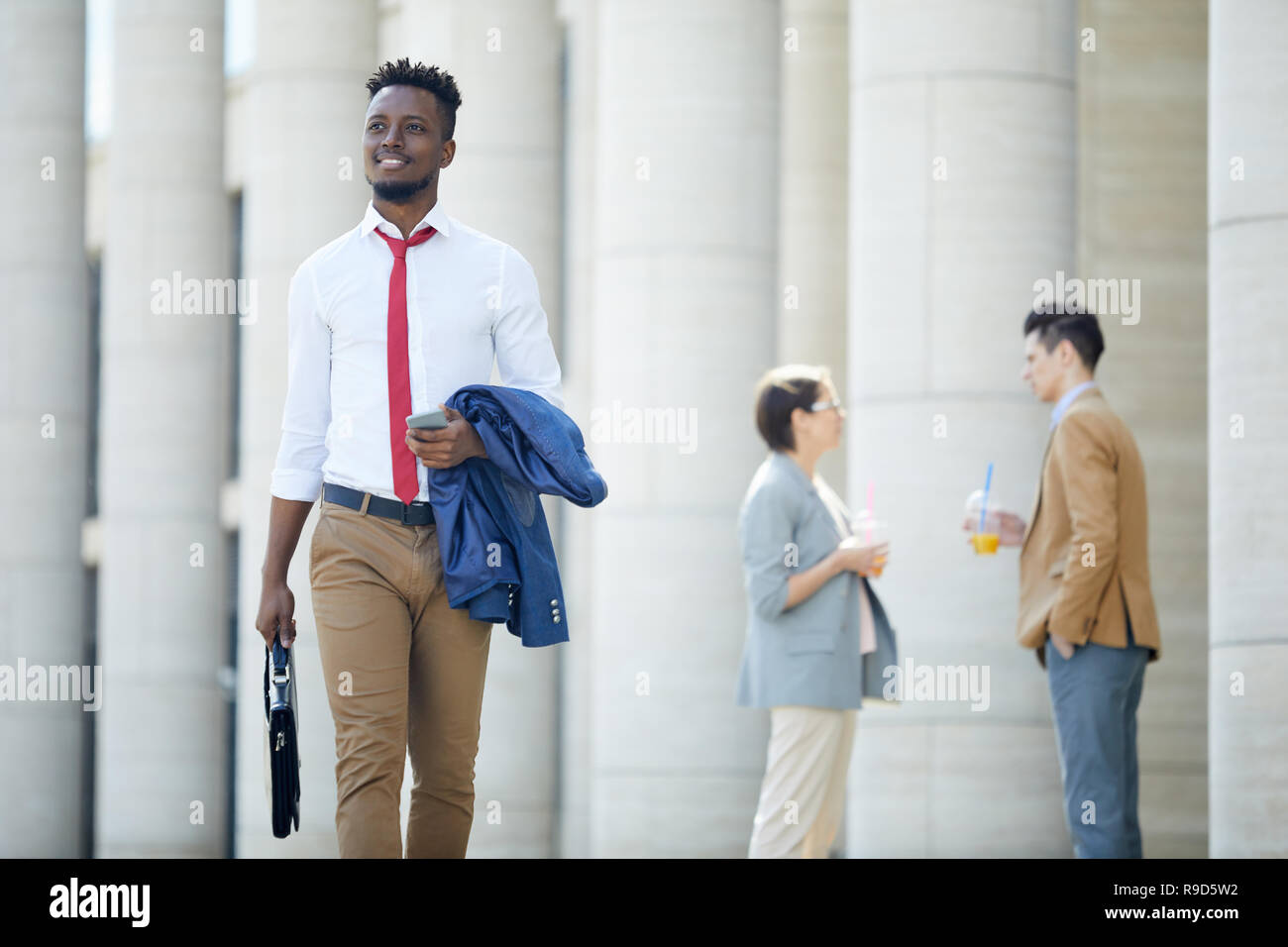 Happy black man going to work Stock Photo - Alamy