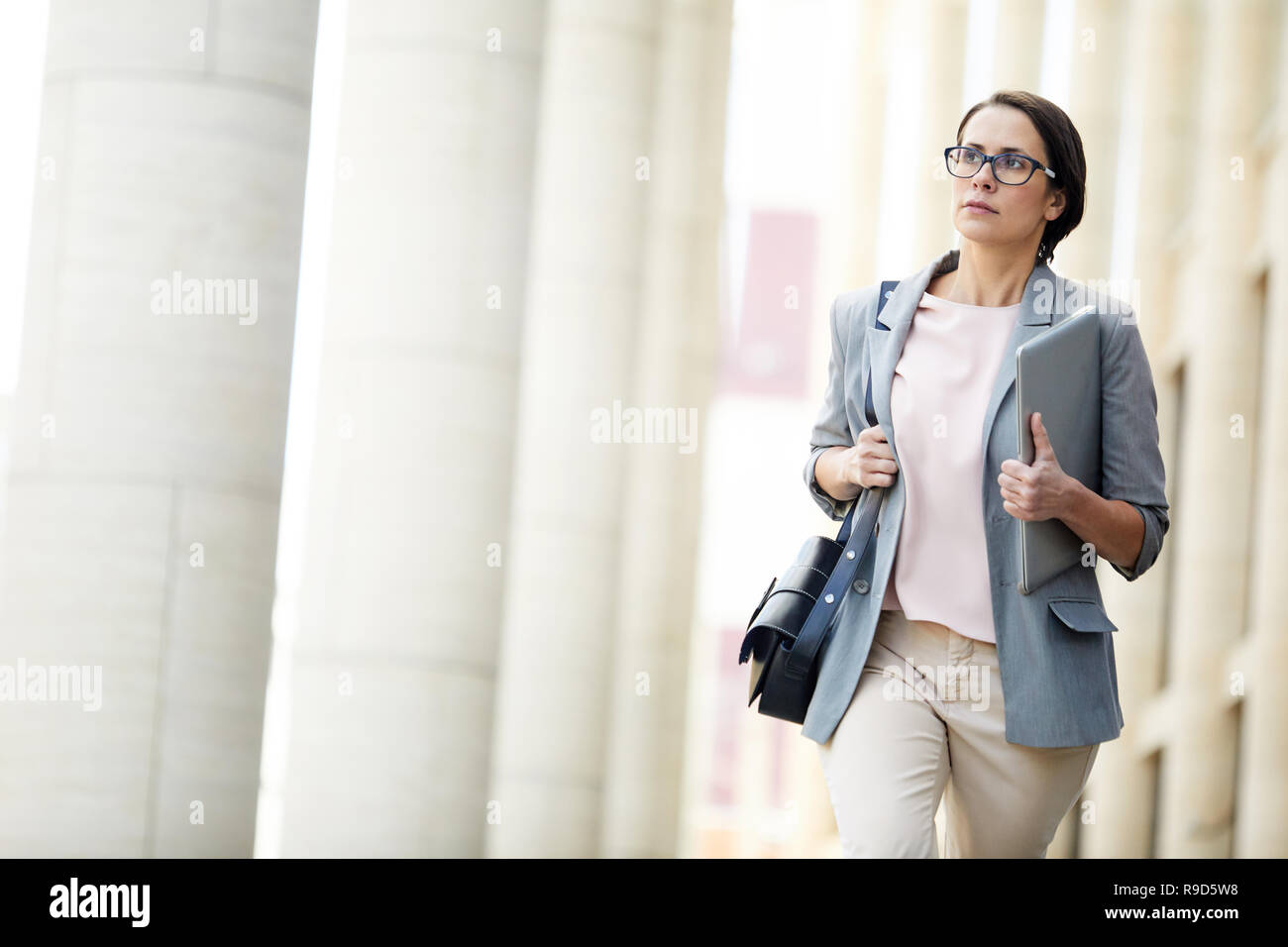 Serious lady hurrying to meeting Stock Photo - Alamy