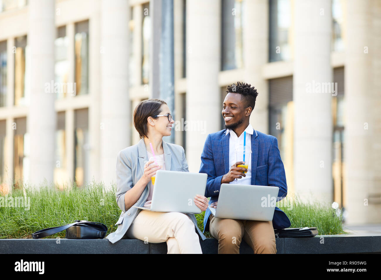 Optimistic colleagues enjoying work Stock Photo - Alamy