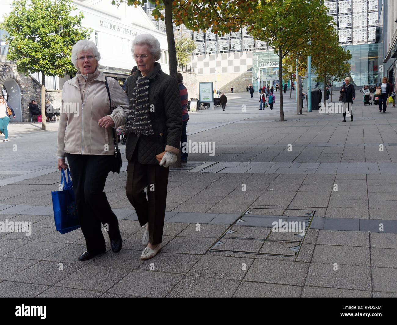 UK High street shoppers shopping and visitors browsing shop fronts ...
