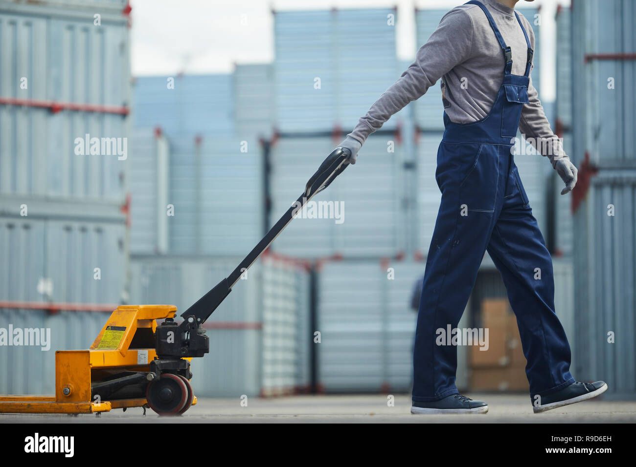 Worker with load cart Stock Photo - Alamy