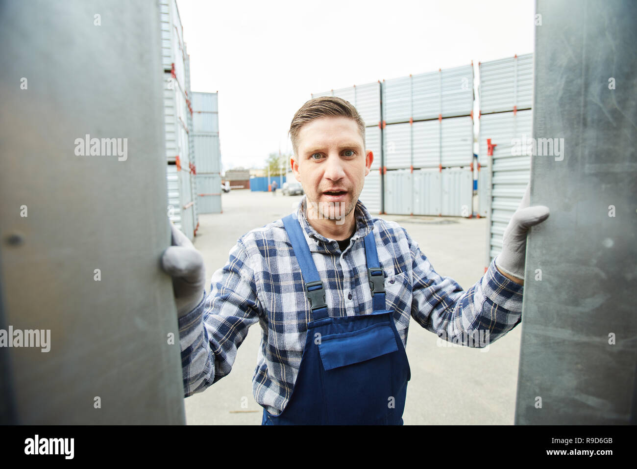 Shocked worker at cargo storage area Stock Photo - Alamy