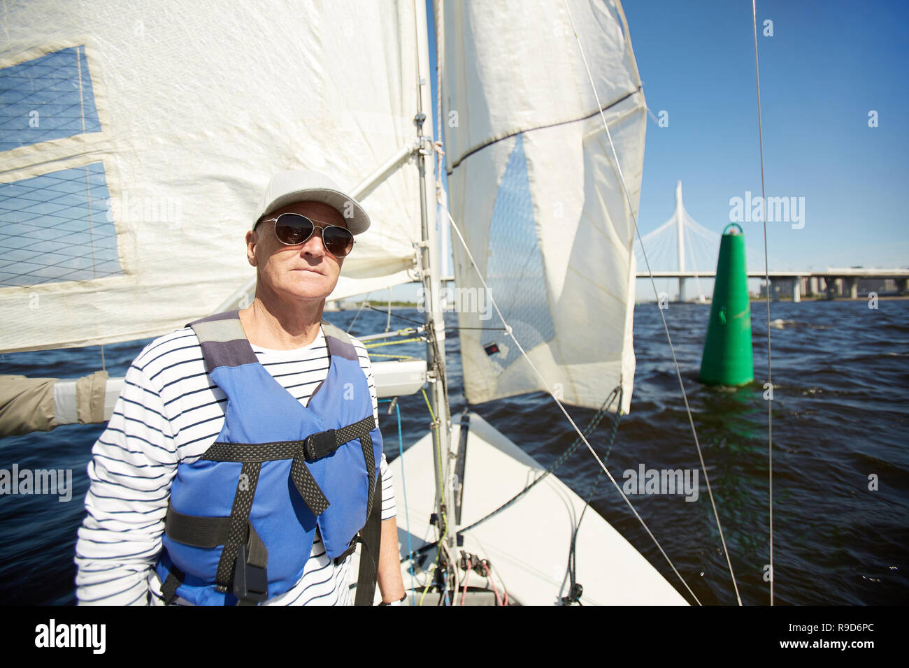 Serious sailor on yacht Stock Photo - Alamy