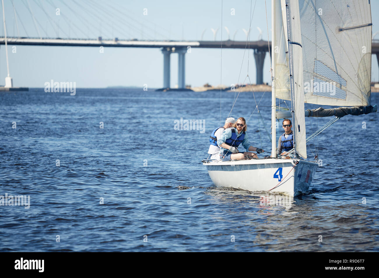 Three friends in sail boat Stock Photo - Alamy