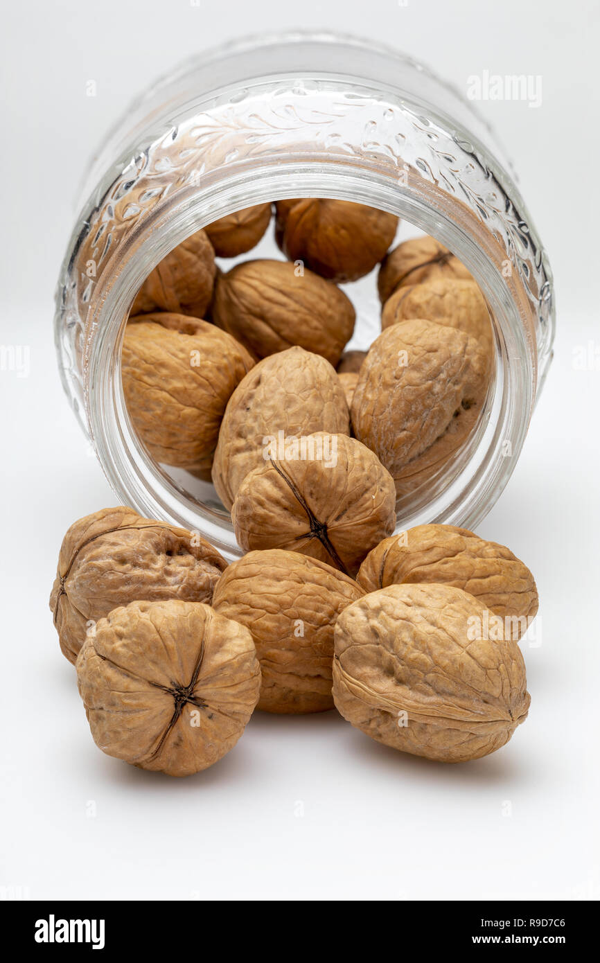 Walnuts in glass jar. Isolated on white background Stock Photo - Alamy