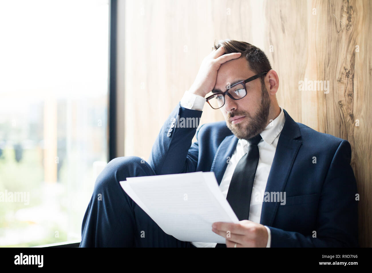 Serious business man reading documents hi-res stock photography and ...