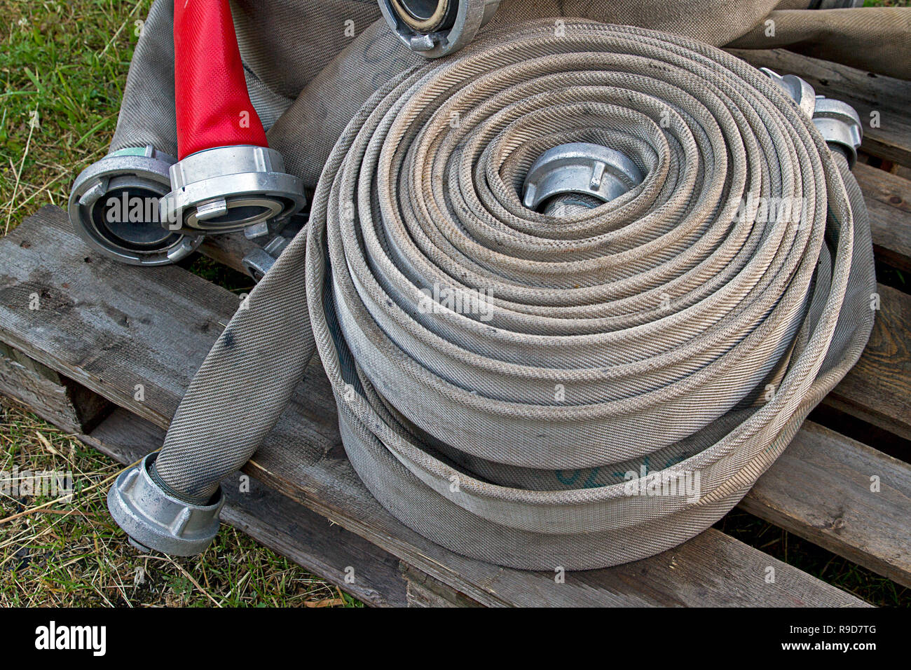 Rolled up fire hose hi-res stock photography and images - Alamy