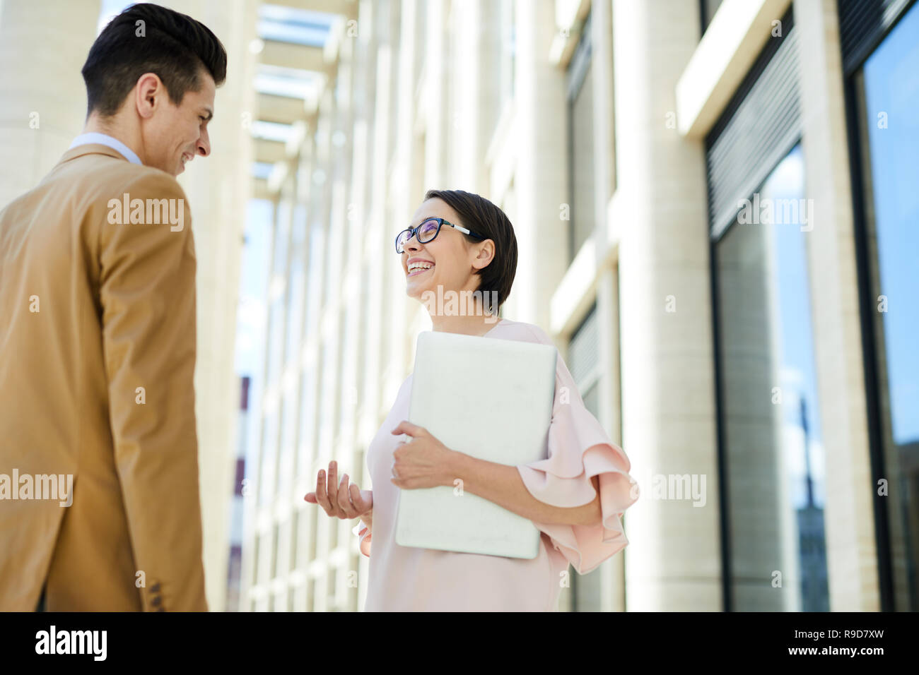 Laughing manager talking colleague hi-res stock photography and images ...