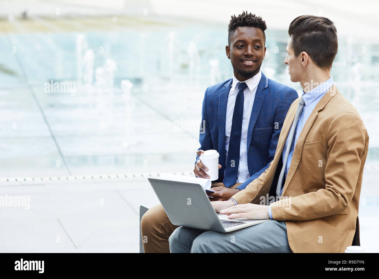 Talking by fountain Stock Photo - Alamy