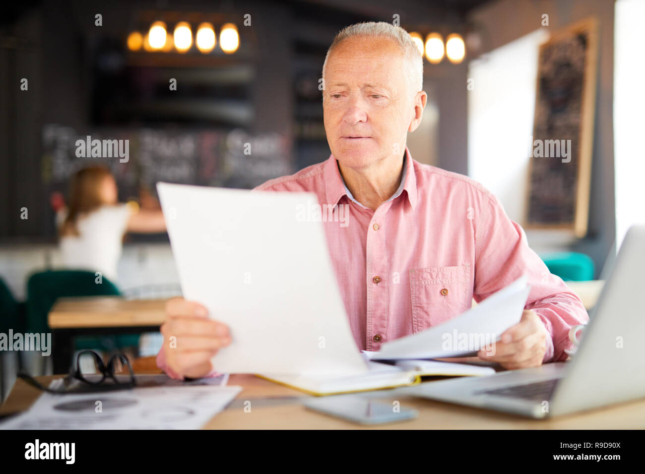 Reading papers in cafe Stock Photo - Alamy