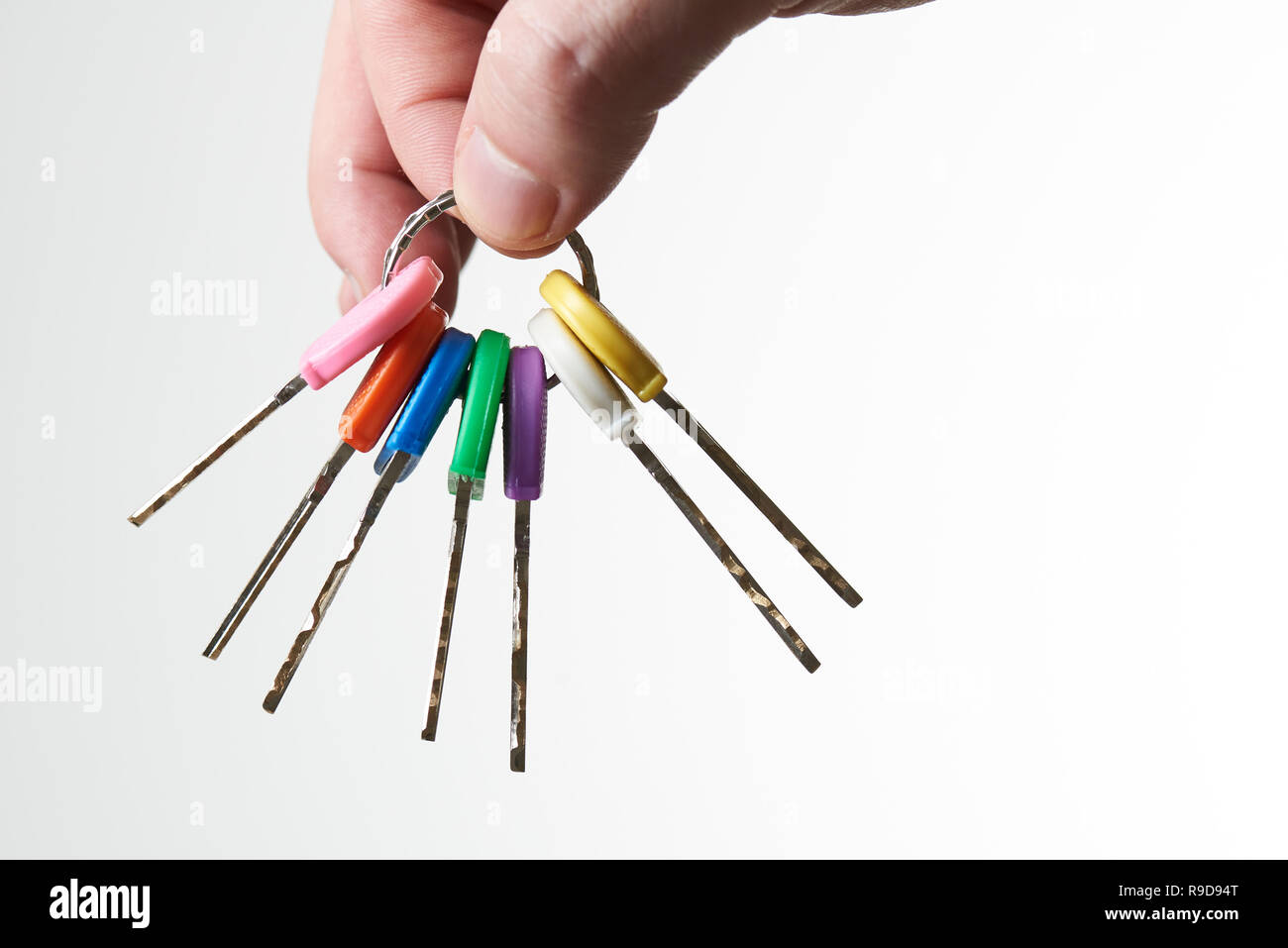 Lock security theme. Colorful keys in human hand Stock Photo - Alamy