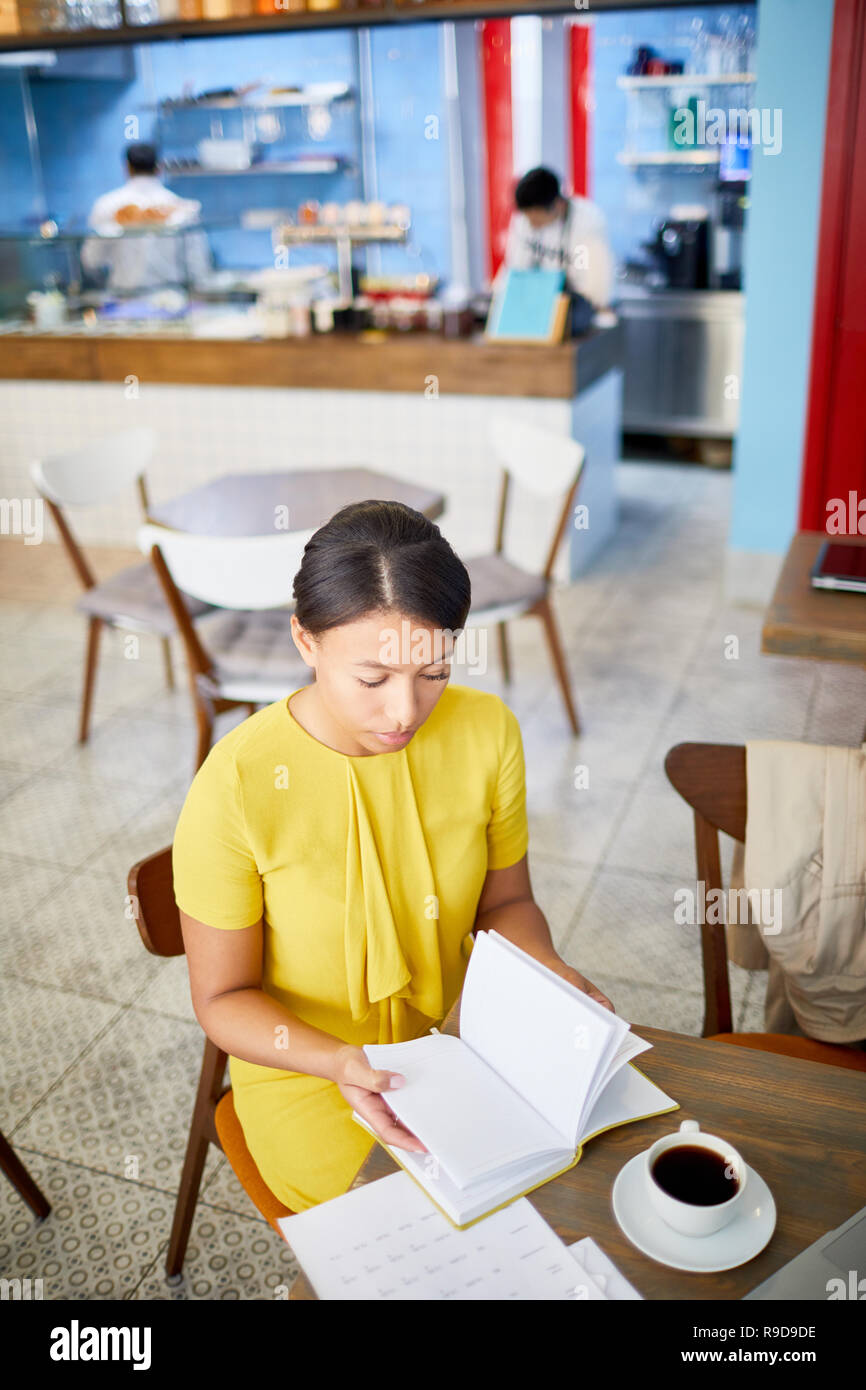 Reading in cafe Stock Photo - Alamy