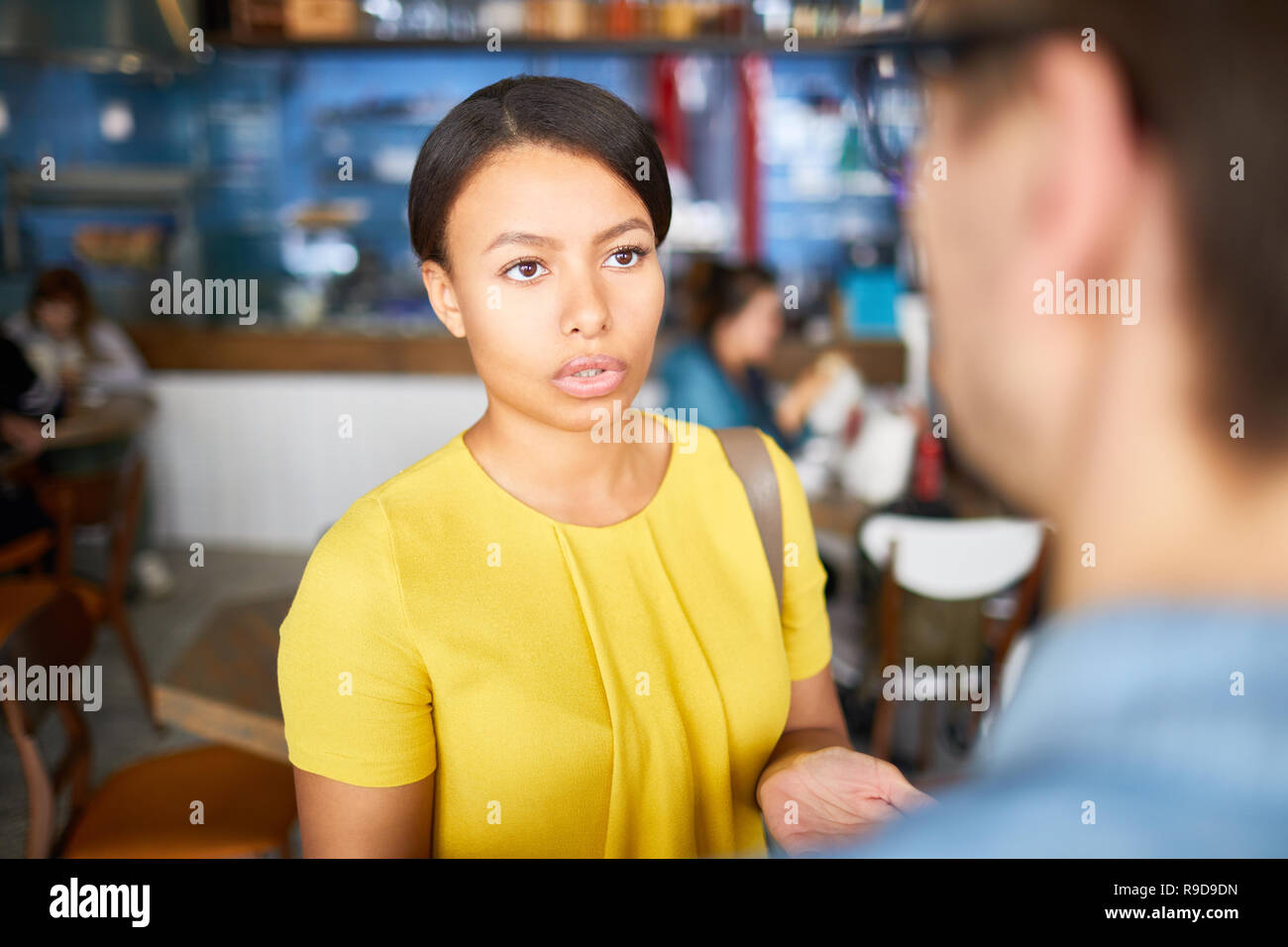 Woman talking to colleague Stock Photo - Alamy