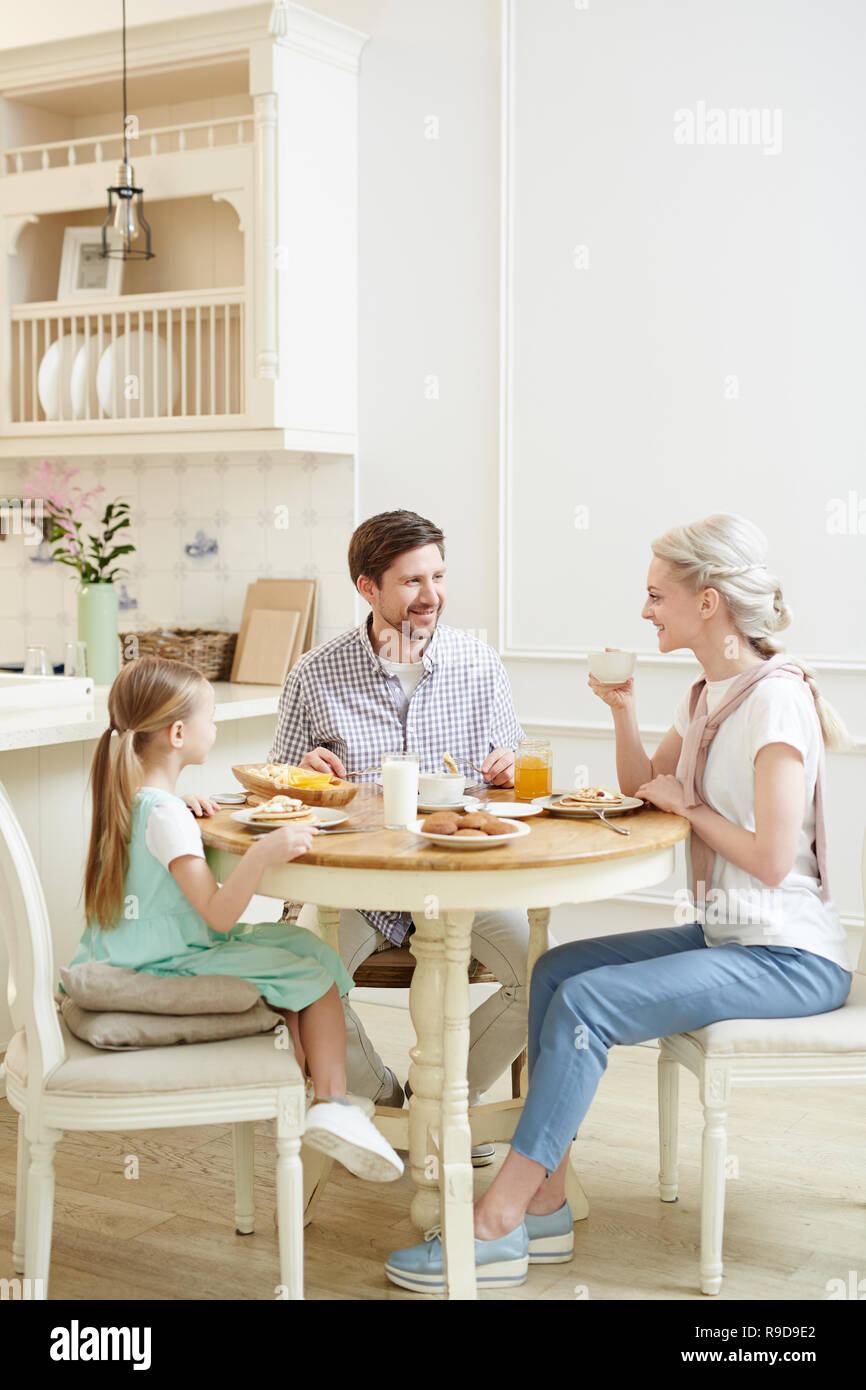 Talkative family enjoying breakfast Stock Photo - Alamy