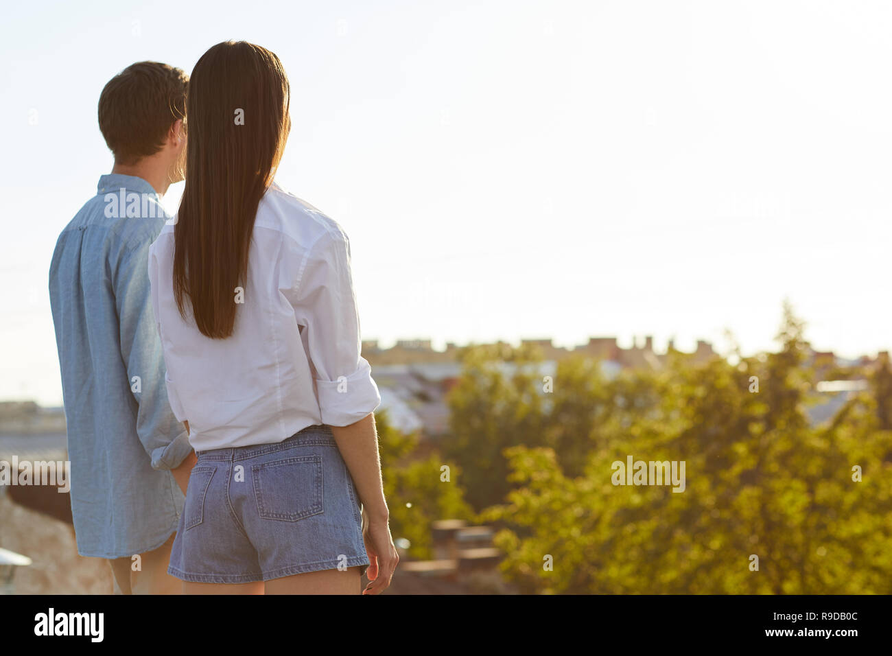 Couple dreaming together on roof Stock Photo - Alamy