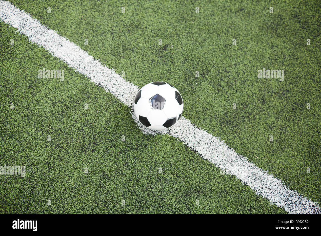 Soccer ball on dividing line Stock Photo - Alamy
