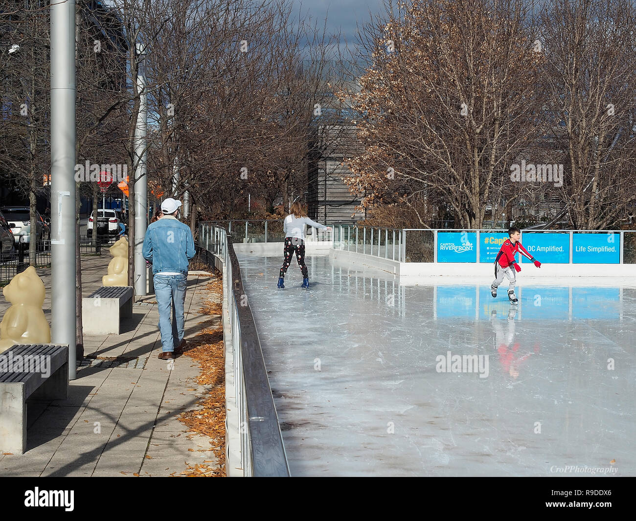Adults and kids at outdoors skating rink in Capitol Riverfront in ...