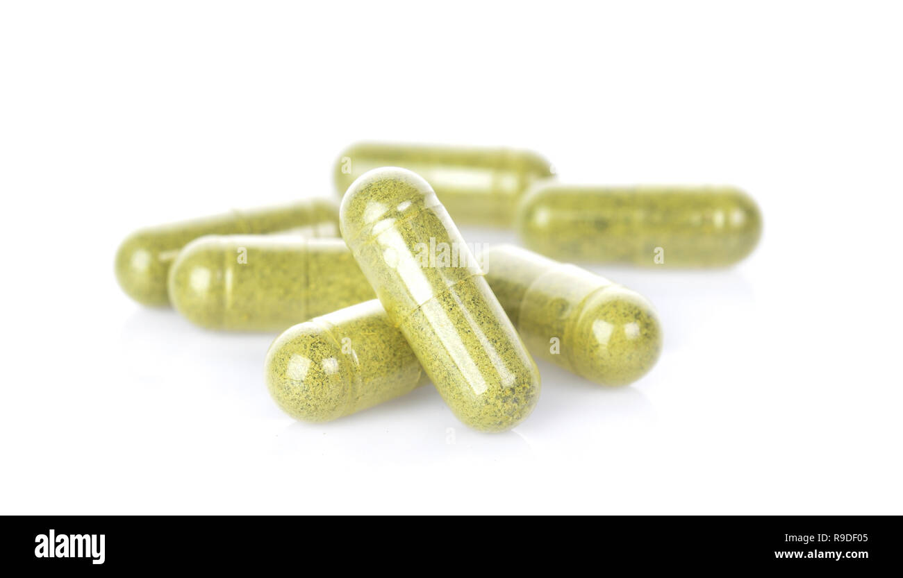 herb capsule with green herbal leaf isolated on white background Stock ...