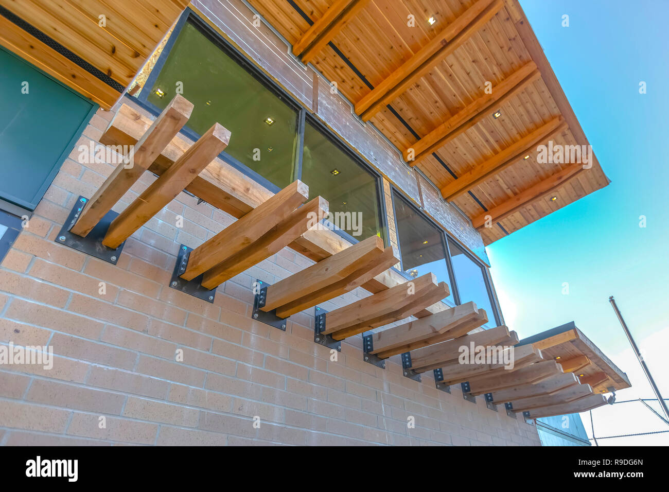 Windows and wooden shade cover modern building Stock Photo - Alamy