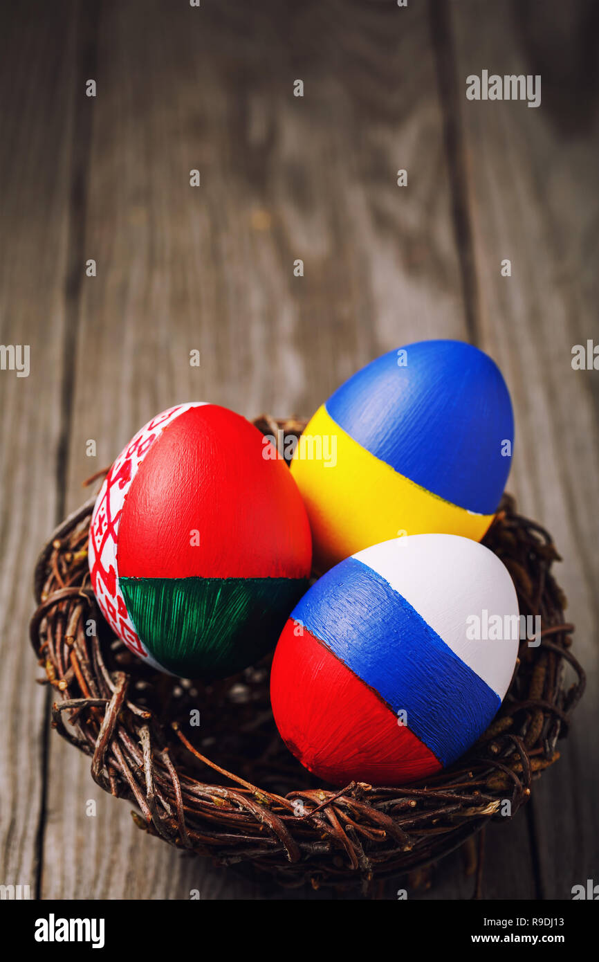 Three Easter eggs in a nest painted in colors of the flags of Russia ...